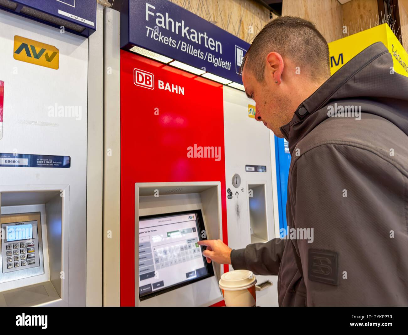 Augsburg, Bavaria, Germany - November 18, 2024: A man buys a ticket at ...