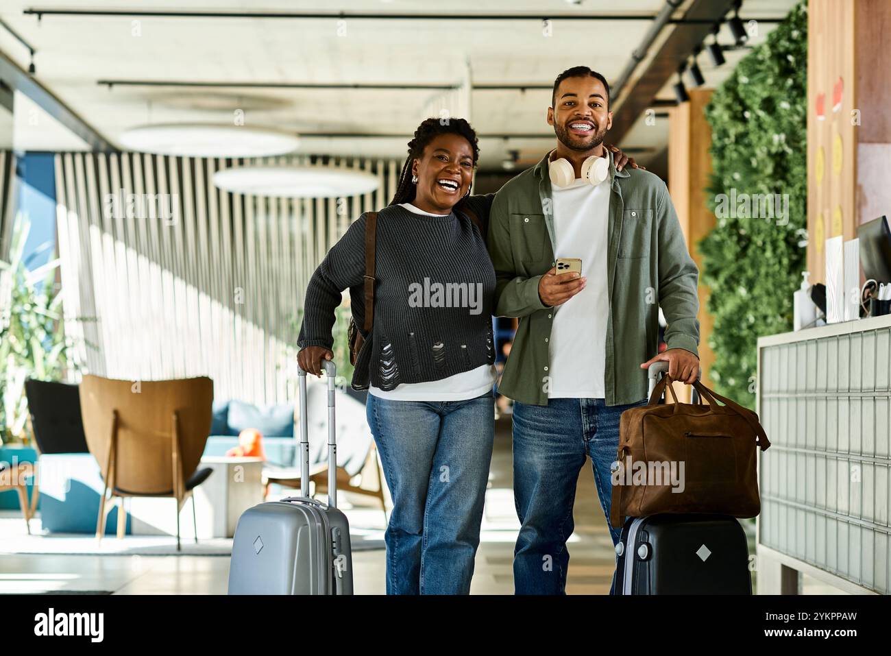 A cheerful couple arrives at the hotel lobby, excited for their ...