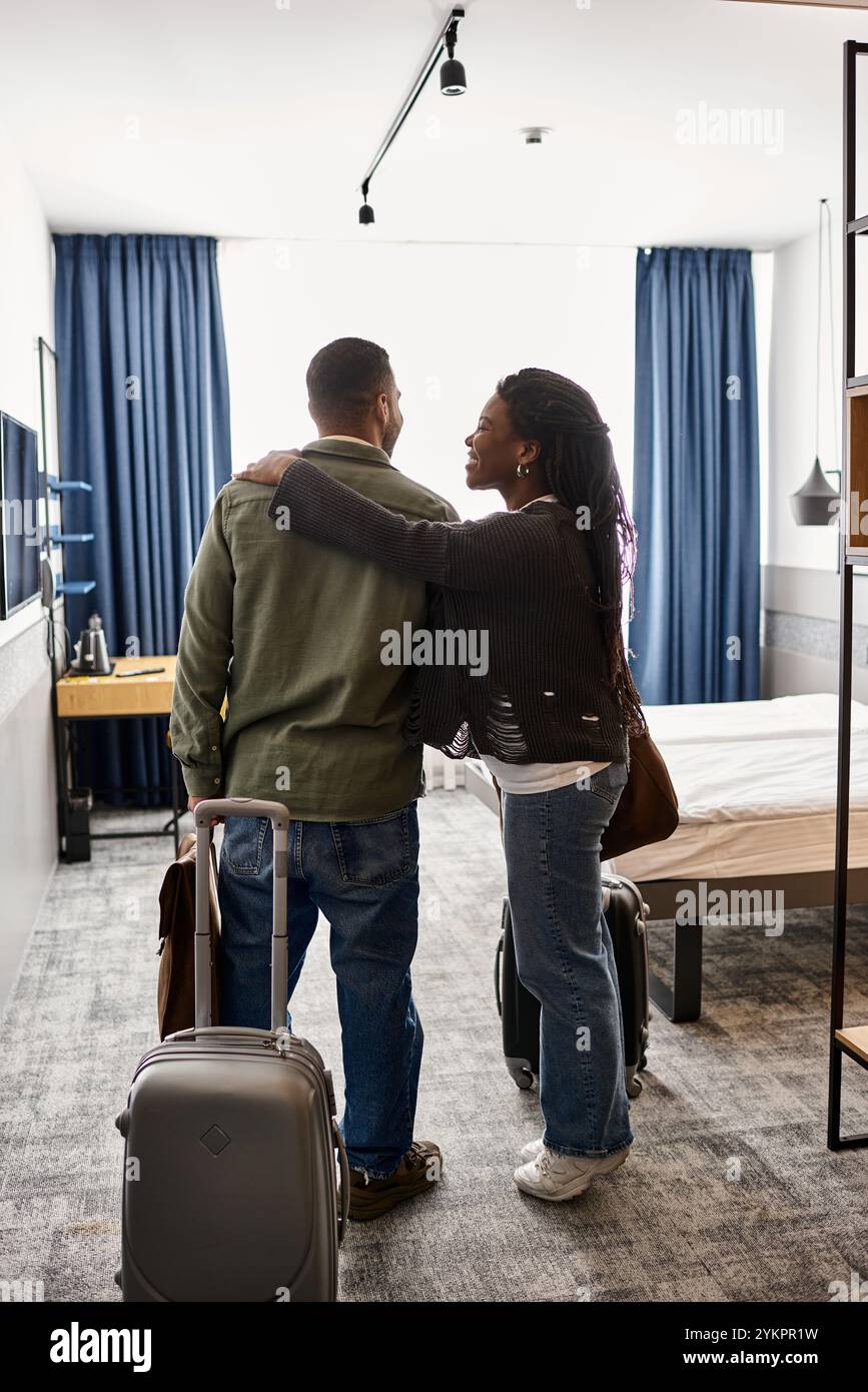 A joyful couple embraces in their hotel room, excited about their ...