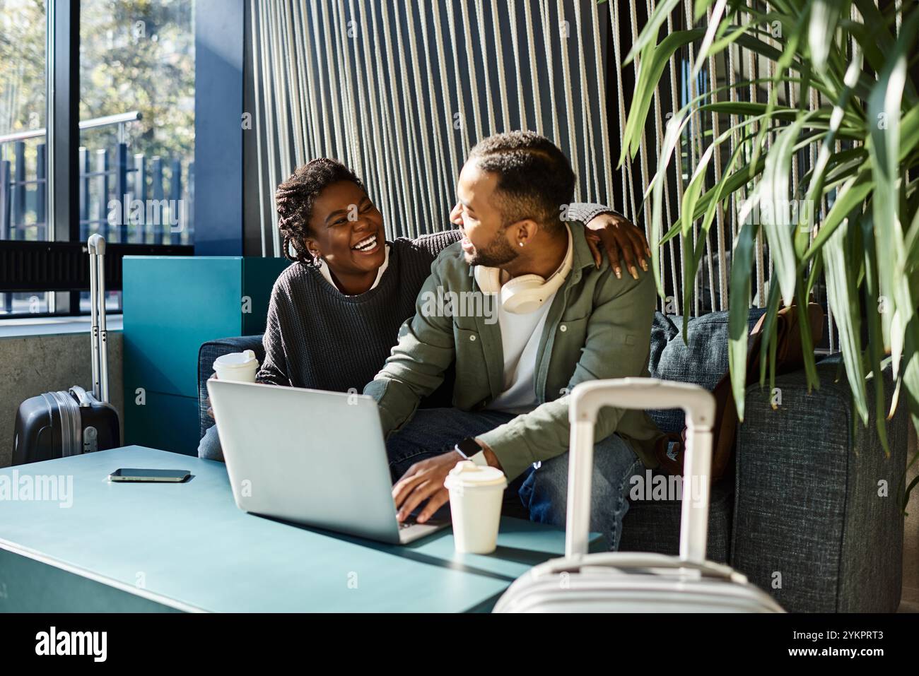 A young couple shares laughter and excitement while planning their ...