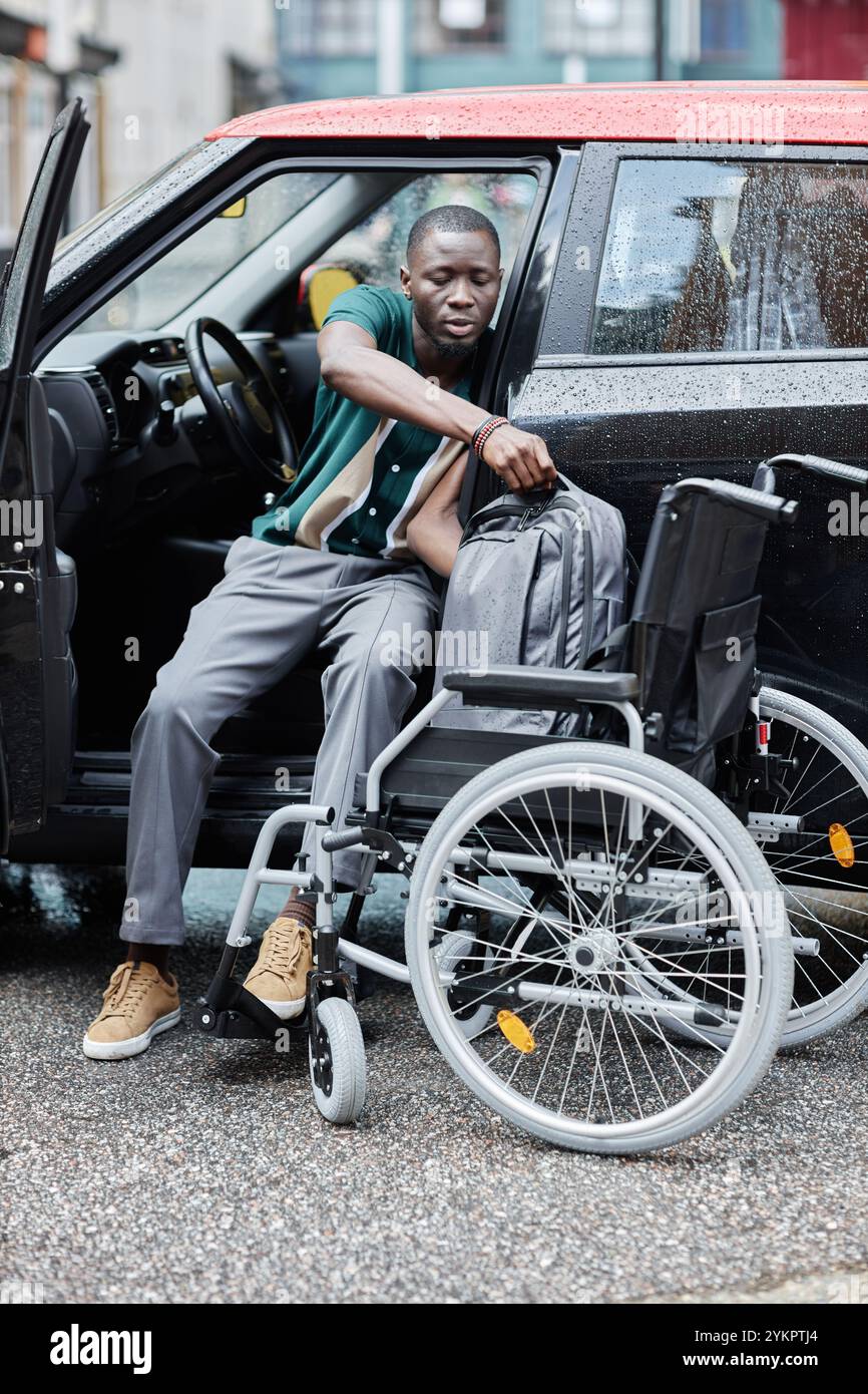 Vertical portrait of young African American man with disability getting ...