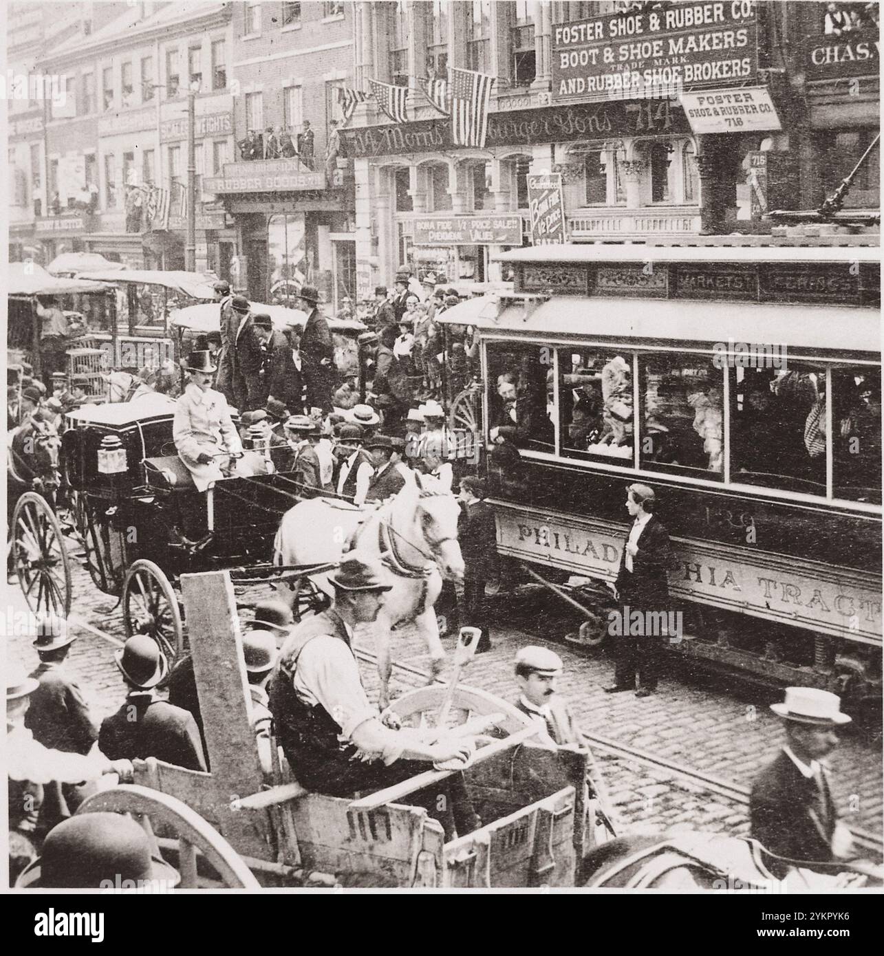 Vintage photo of horse-drawn wagons and carriages, an electric trolley ...