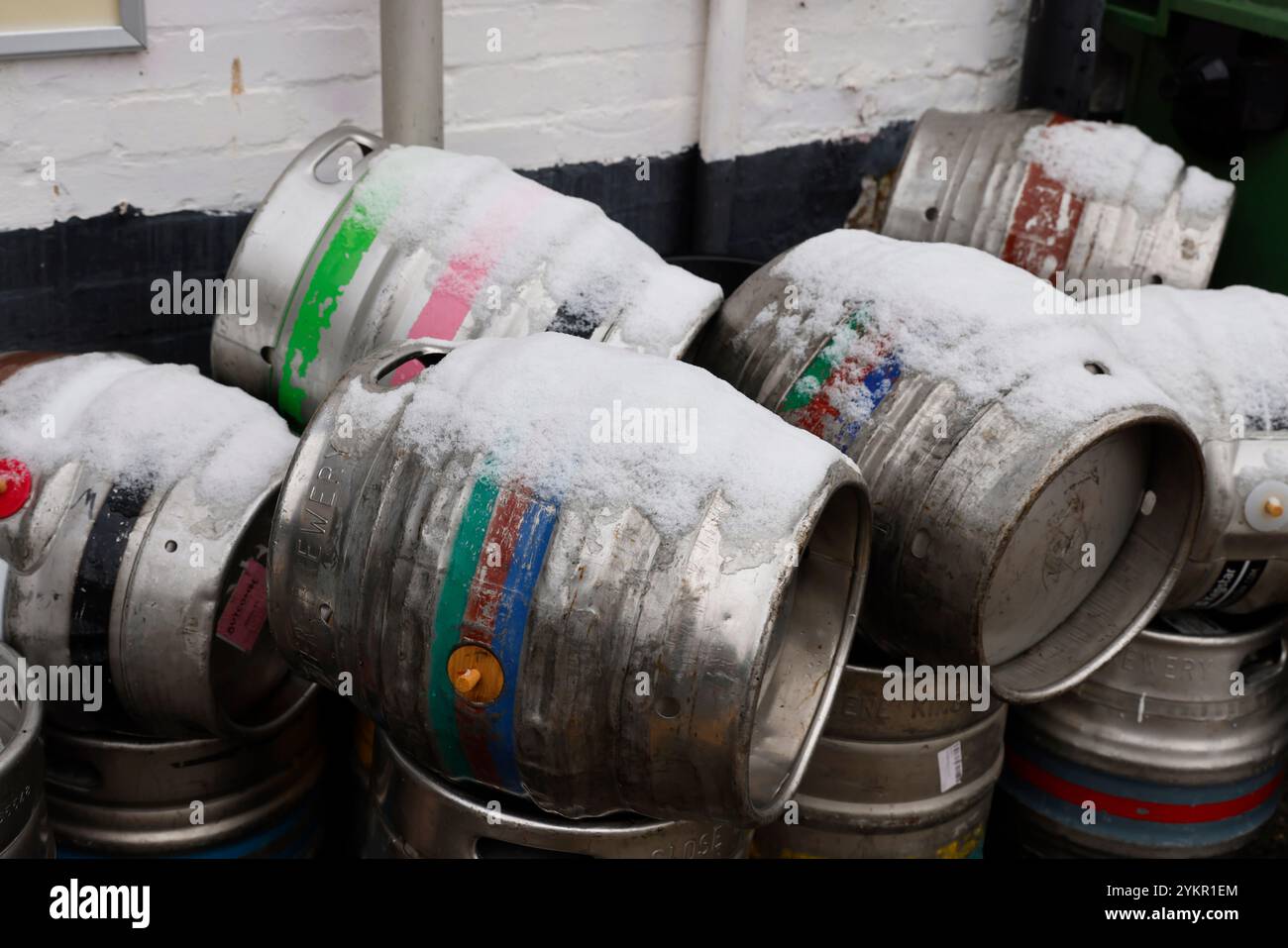 Snow topped empty beer barrel kegs outside pub in Ledbury ...