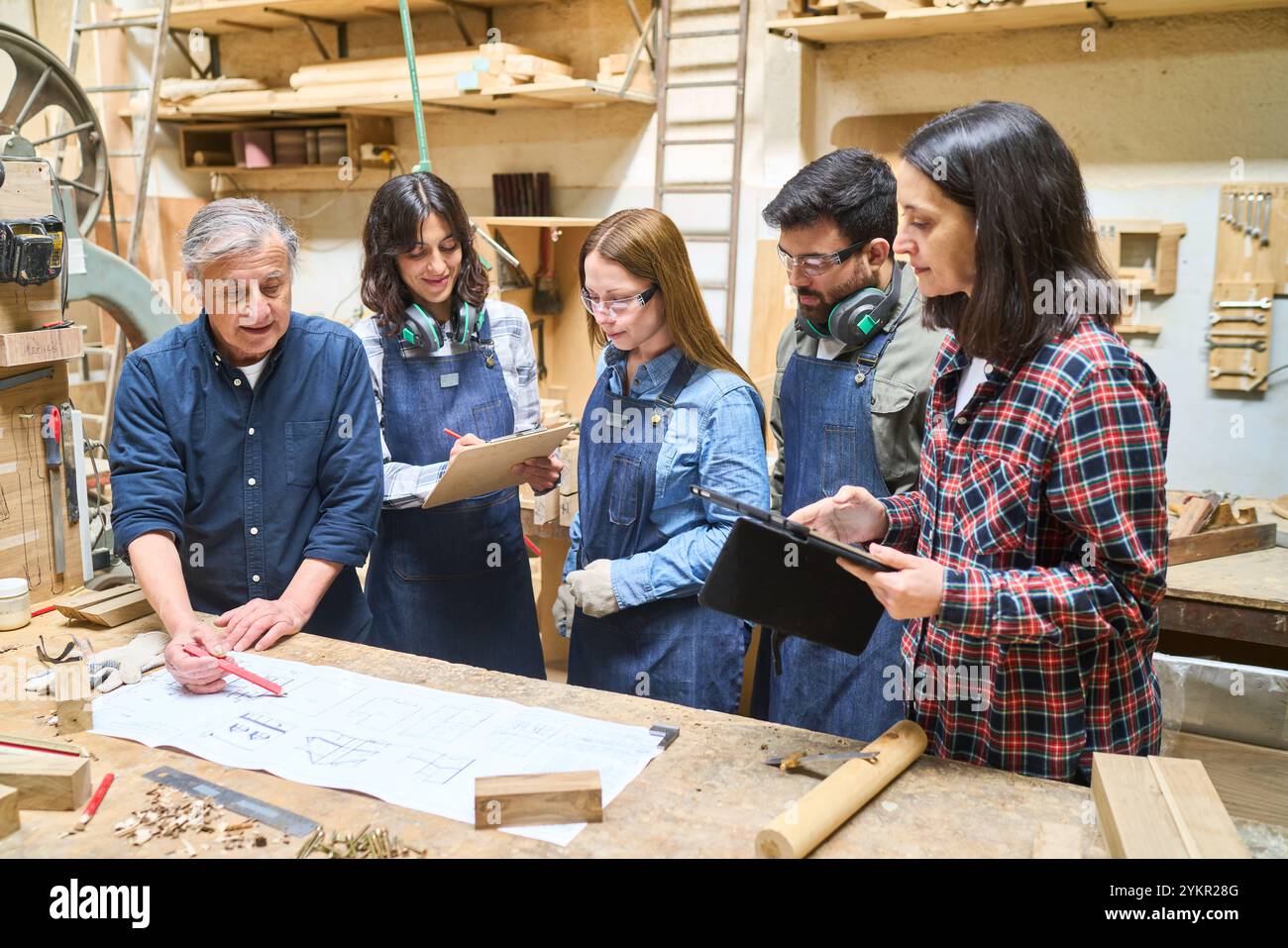 A diverse group of workers in a lumberyard, demonstrating teamwork and ...