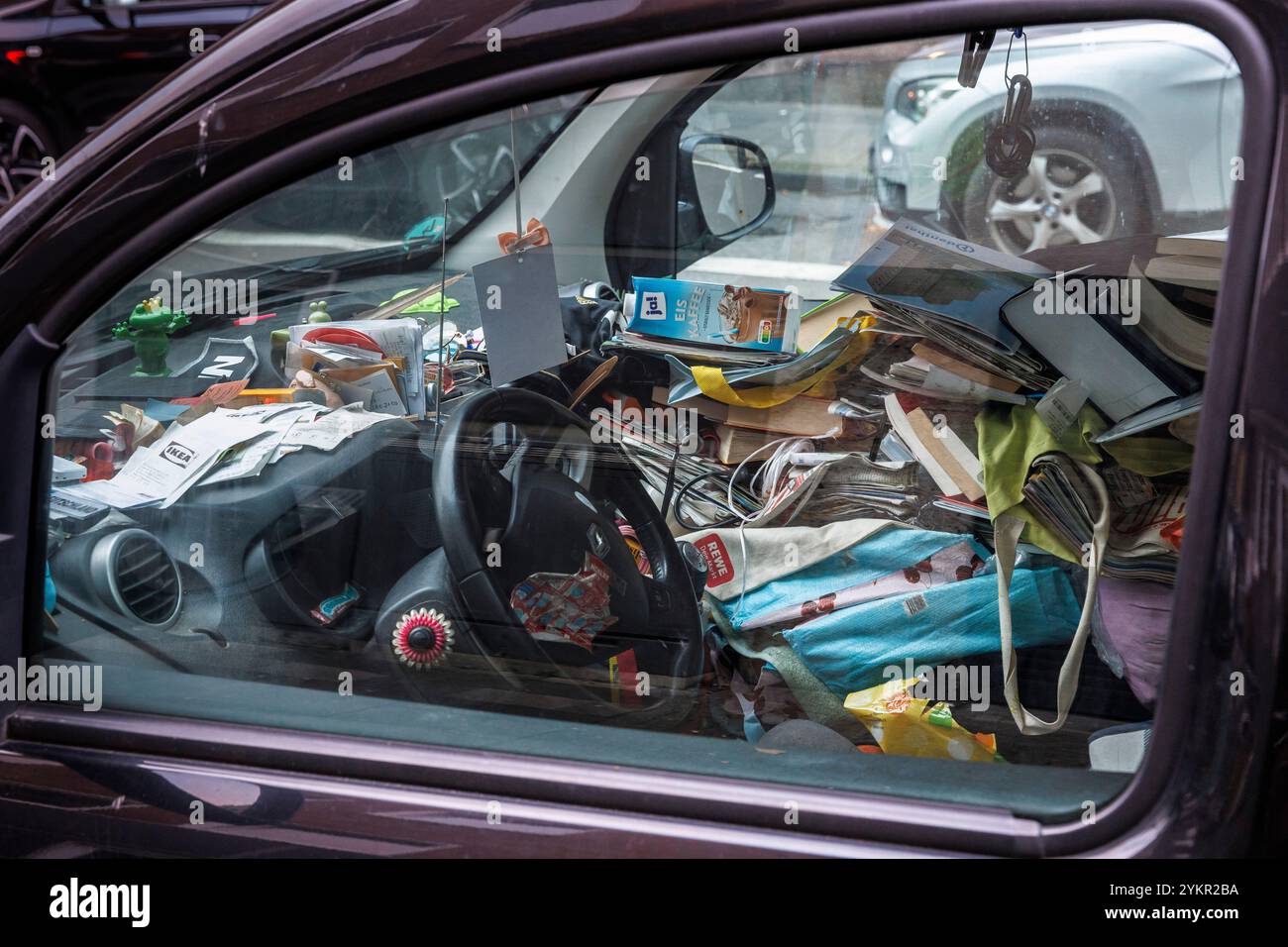 passenger seat and dashboard of a car completely littered with papers ...