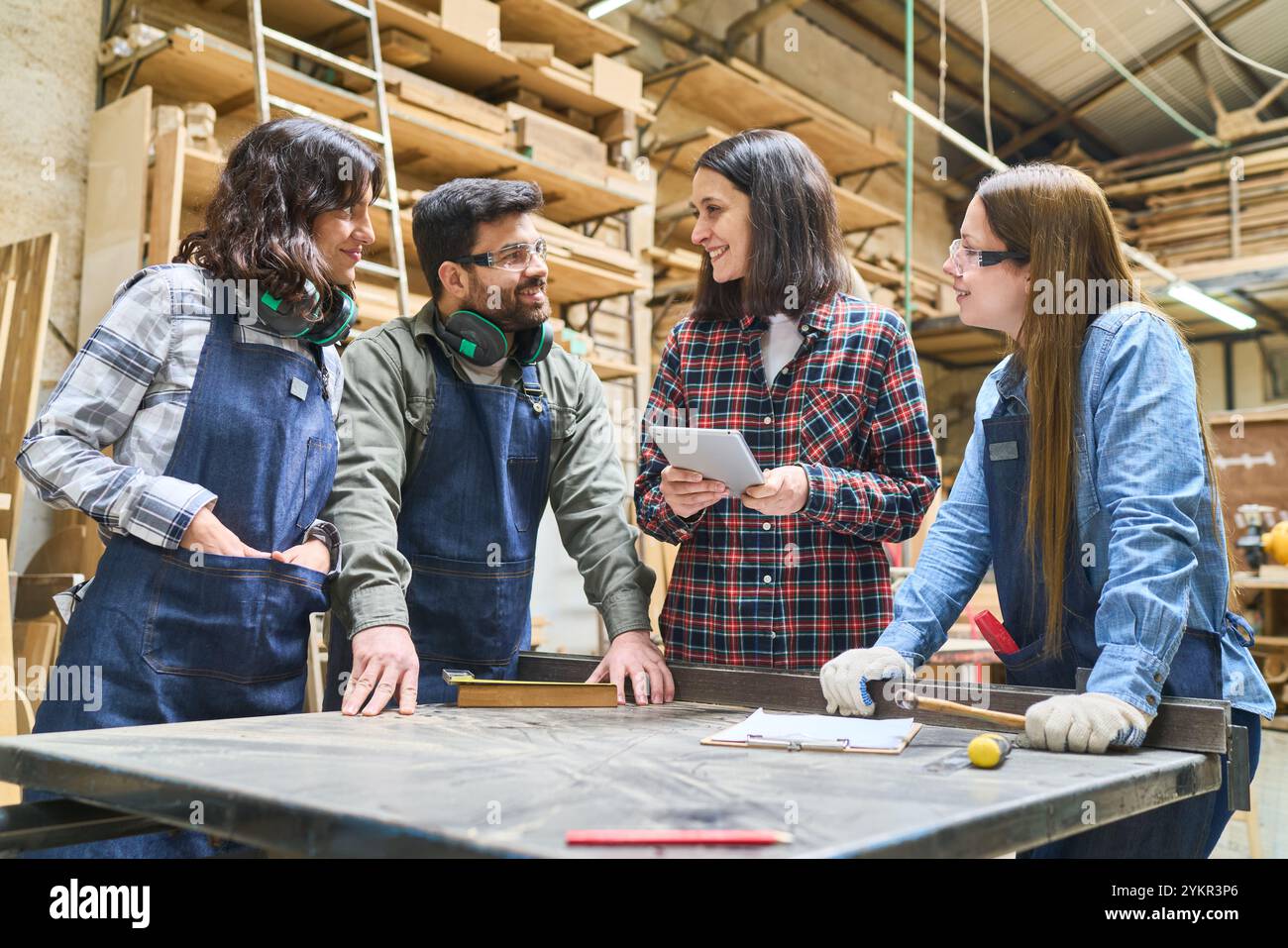 Diverse group of workers collaborating in a lumberyard, focusing on ...