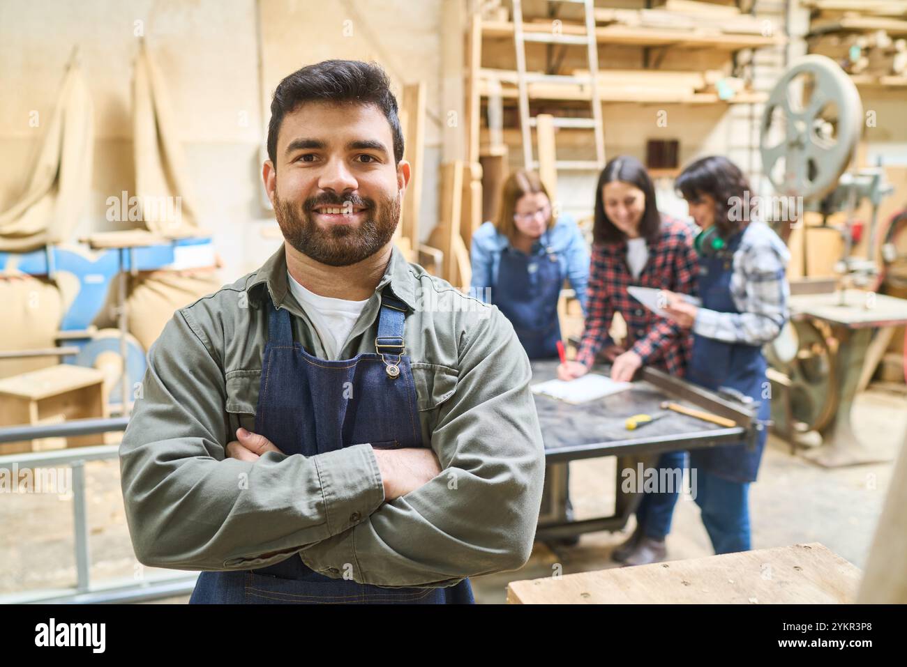 A confident worker in a lumberyard smiles, with a team collaborating ...