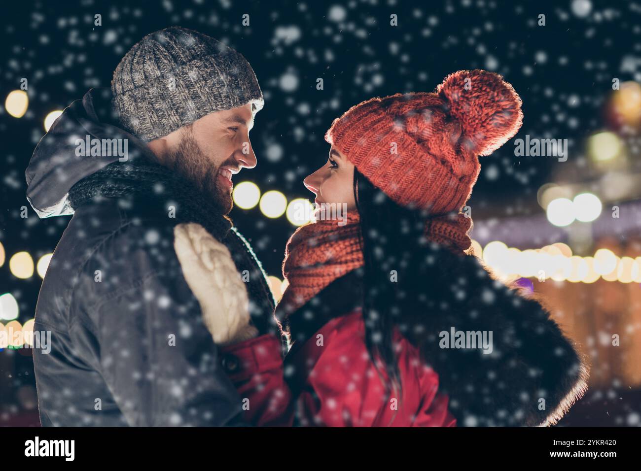 Photo of two affectionate people in love at midnight standing opposite ...