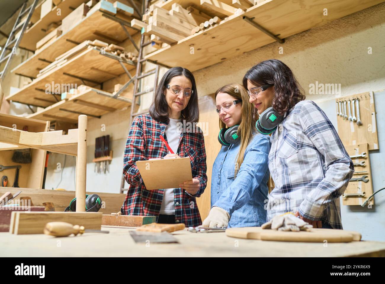 A group of workers, including a mentor and apprentices, collaborate in ...