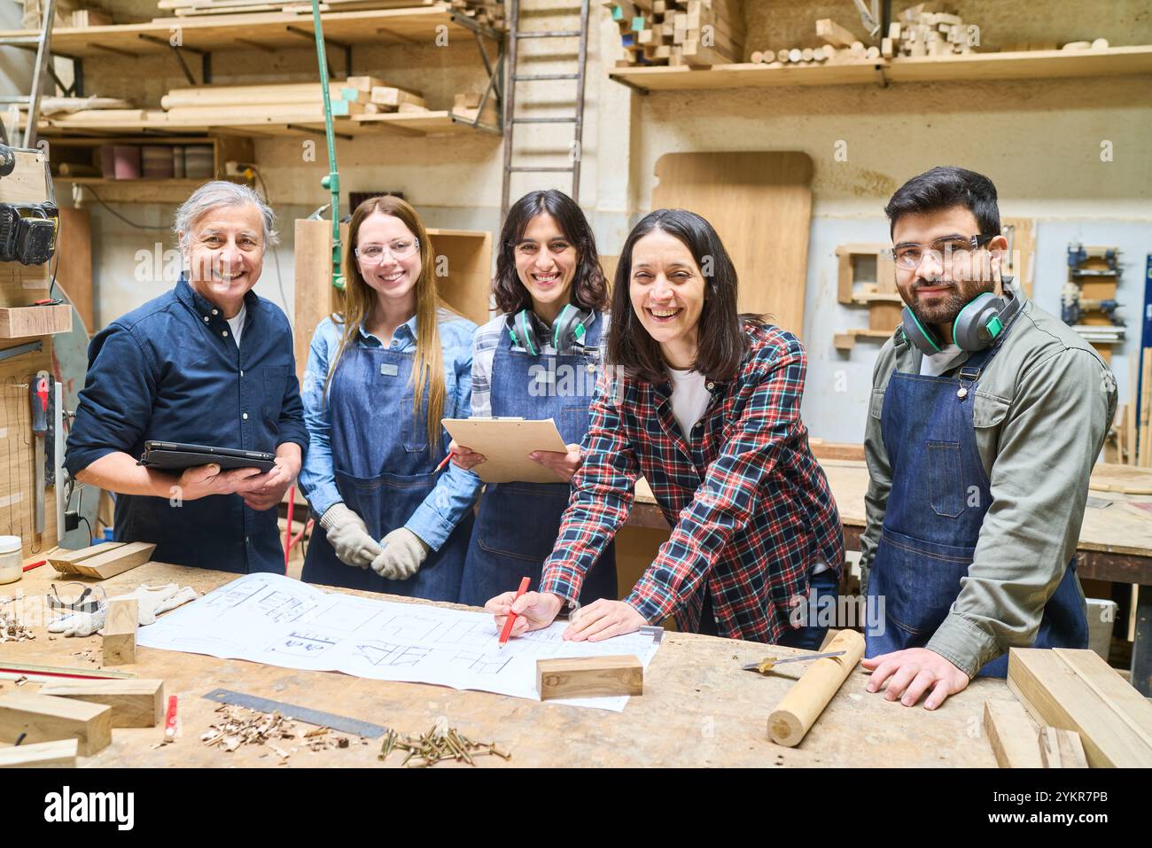 A diverse group of people collaborating in a lumberyard, focusing on ...