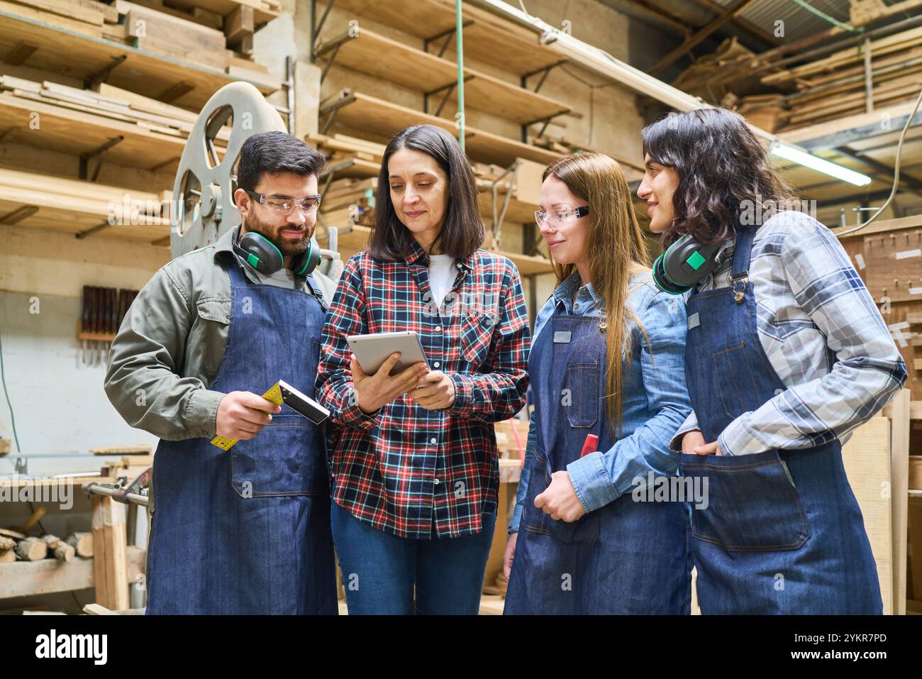 A group of professionals, featuring young apprentices and senior ...
