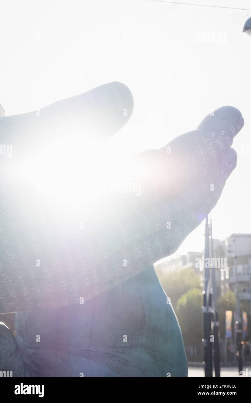 Amsterdam, Netherlands - November 02, 2024 : Monumental bronze helping ...