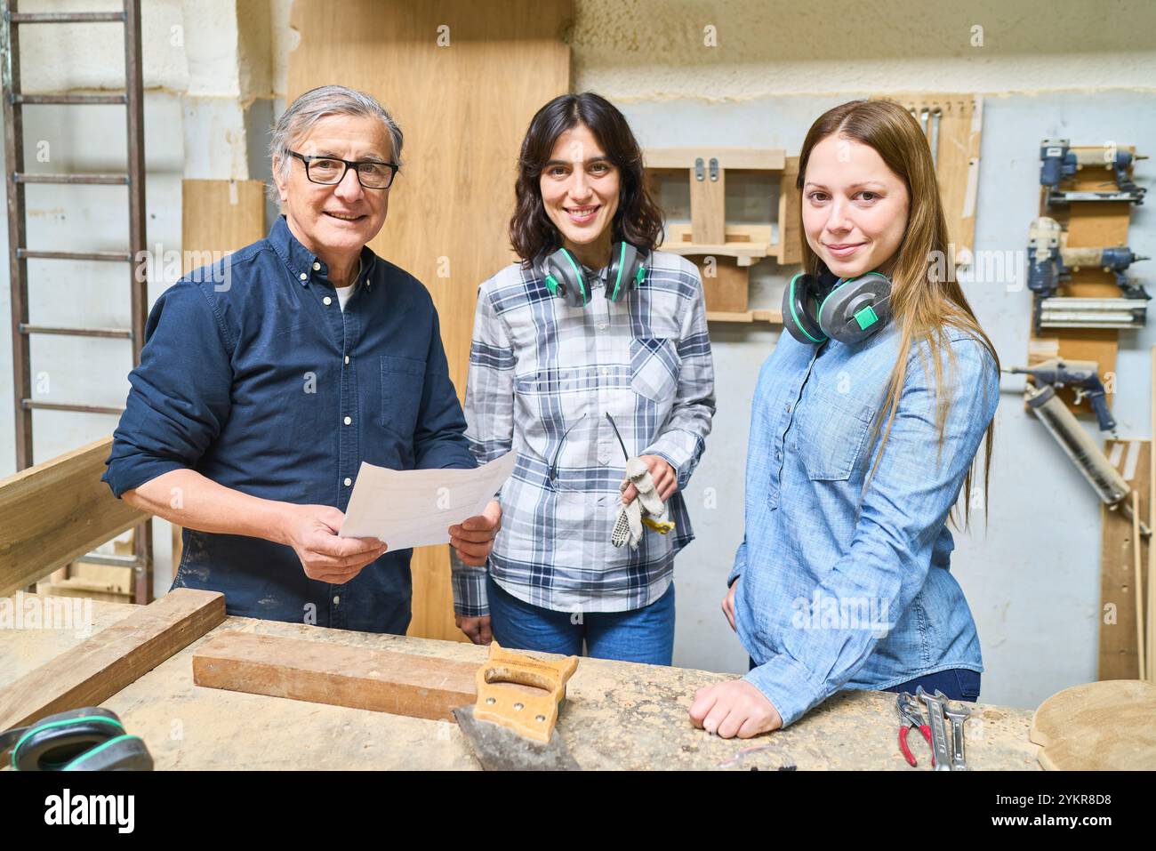 A diverse team in a lumberyard demonstrates teamwork and collaboration ...