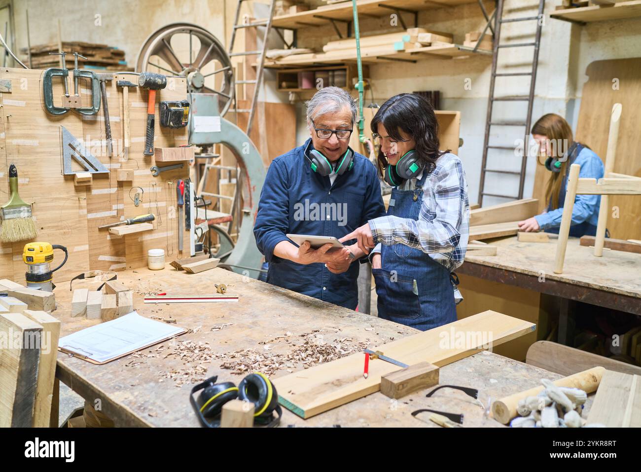 Older and younger workers collaborate in a vibrant lumberyard, emphasizing training and teamwork ...