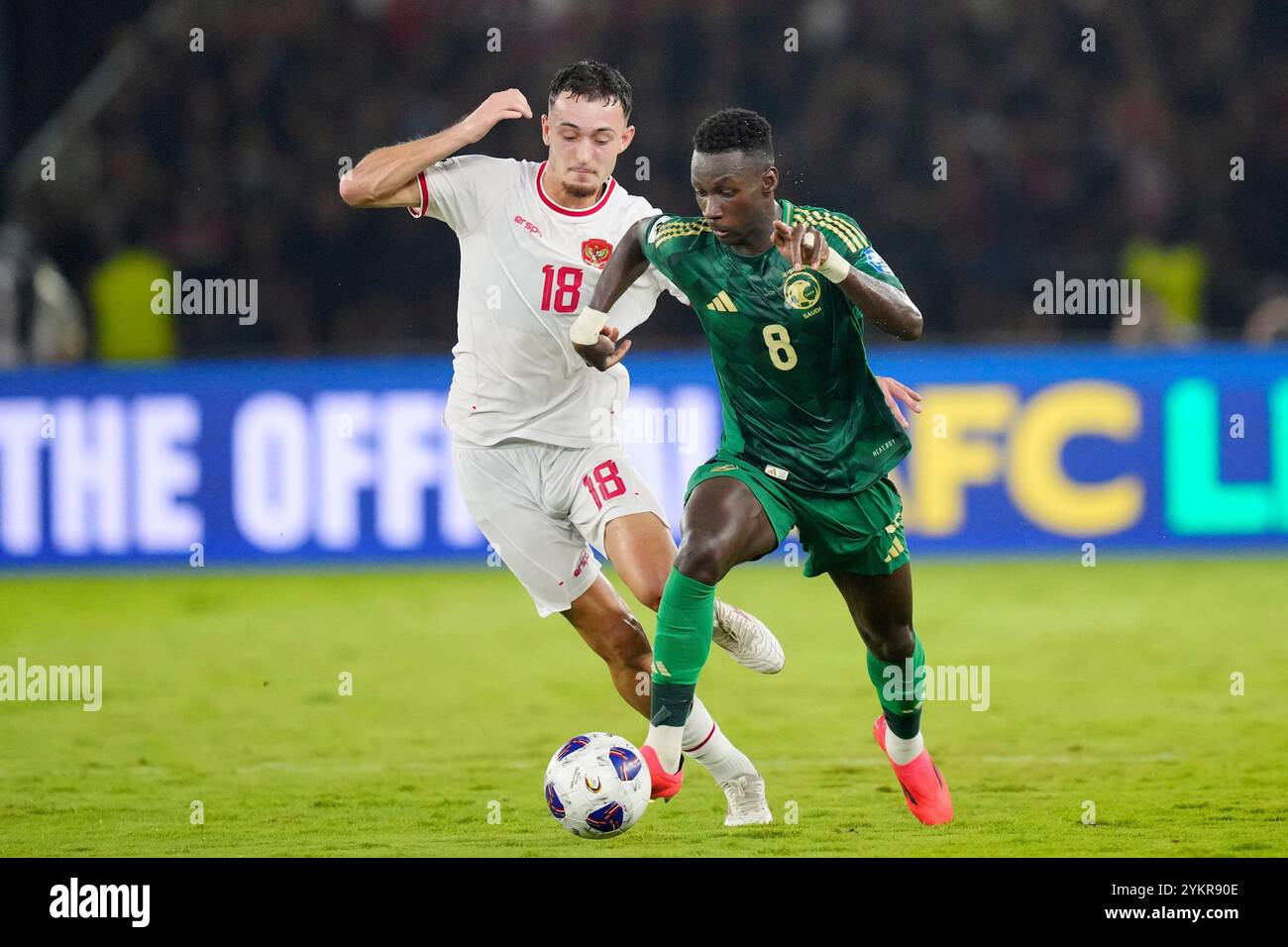 Saudi Arabia's Marwan Al Sahafi, right, battles for the ball against ...