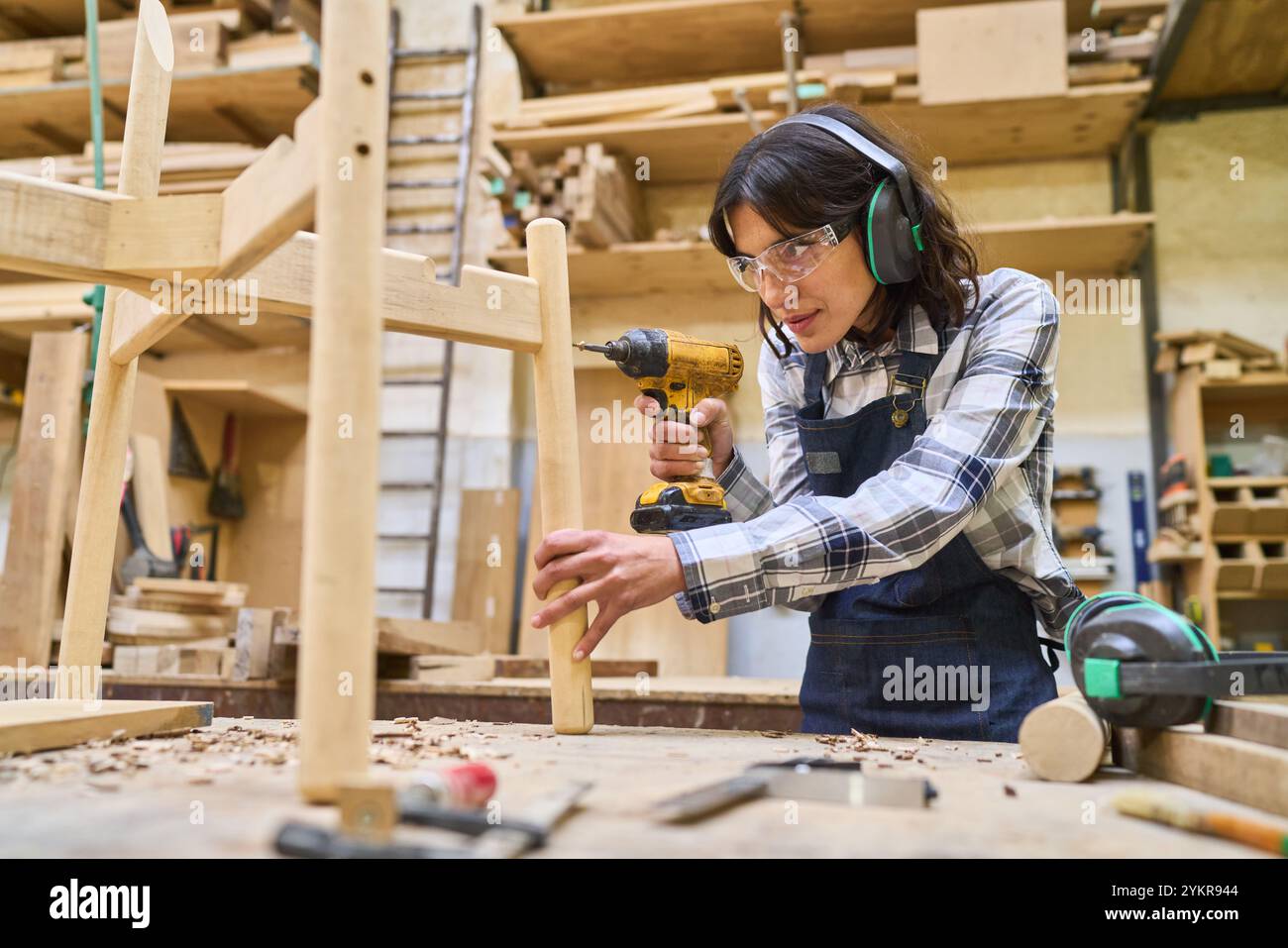 Skilled worker confidently uses drill hi-res stock photography and ...