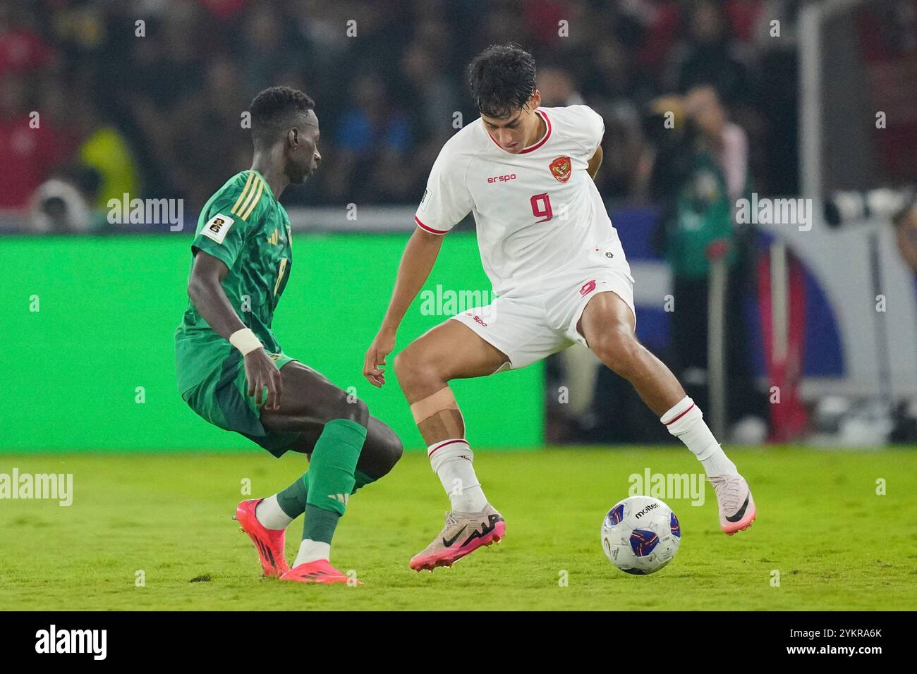 Saudi Arabia's Marwan Al Sahafi, left, battles for the ball against ...