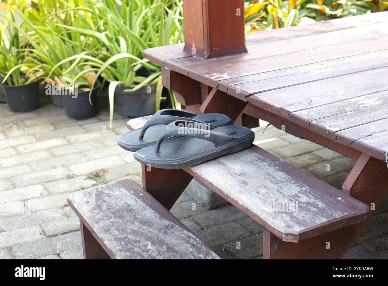 Black flip flops outside the house Stock Photo - Alamy