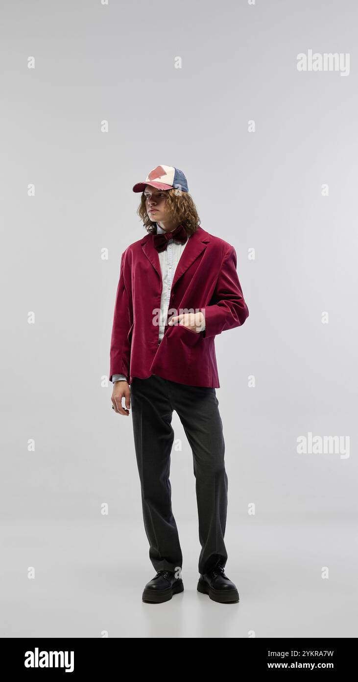 Full-length portrait of stylish young guy with silver rings, wearing ...