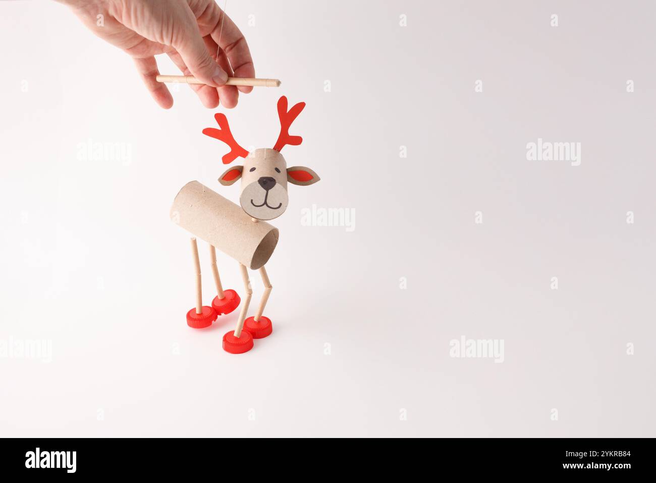 DIY reindeer puppet made from cardboard tubes, red plastic caps, and ...