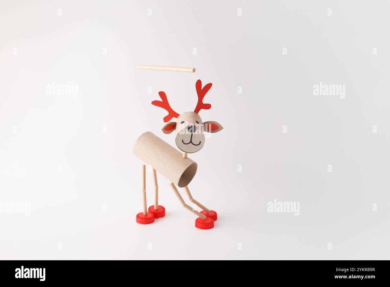 DIY reindeer puppet made from cardboard tubes, red plastic caps, and ...