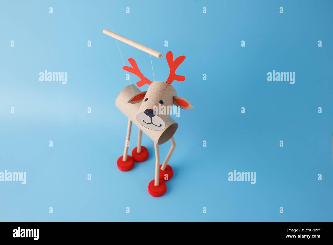DIY reindeer puppet made from cardboard tubes, red bottle caps, and ...