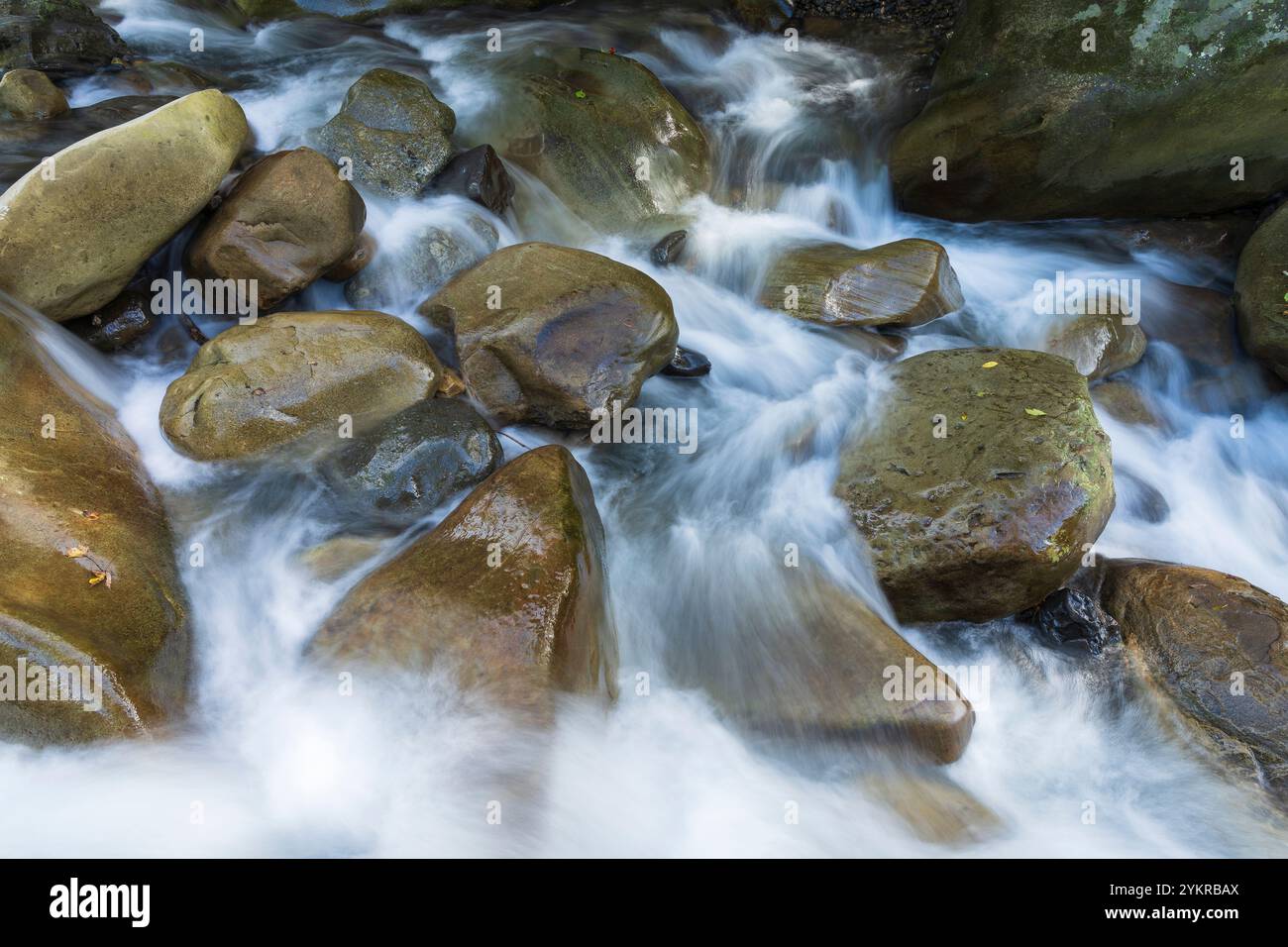 Slow shutter image of water flowing through the rocks creating a sooth ...
