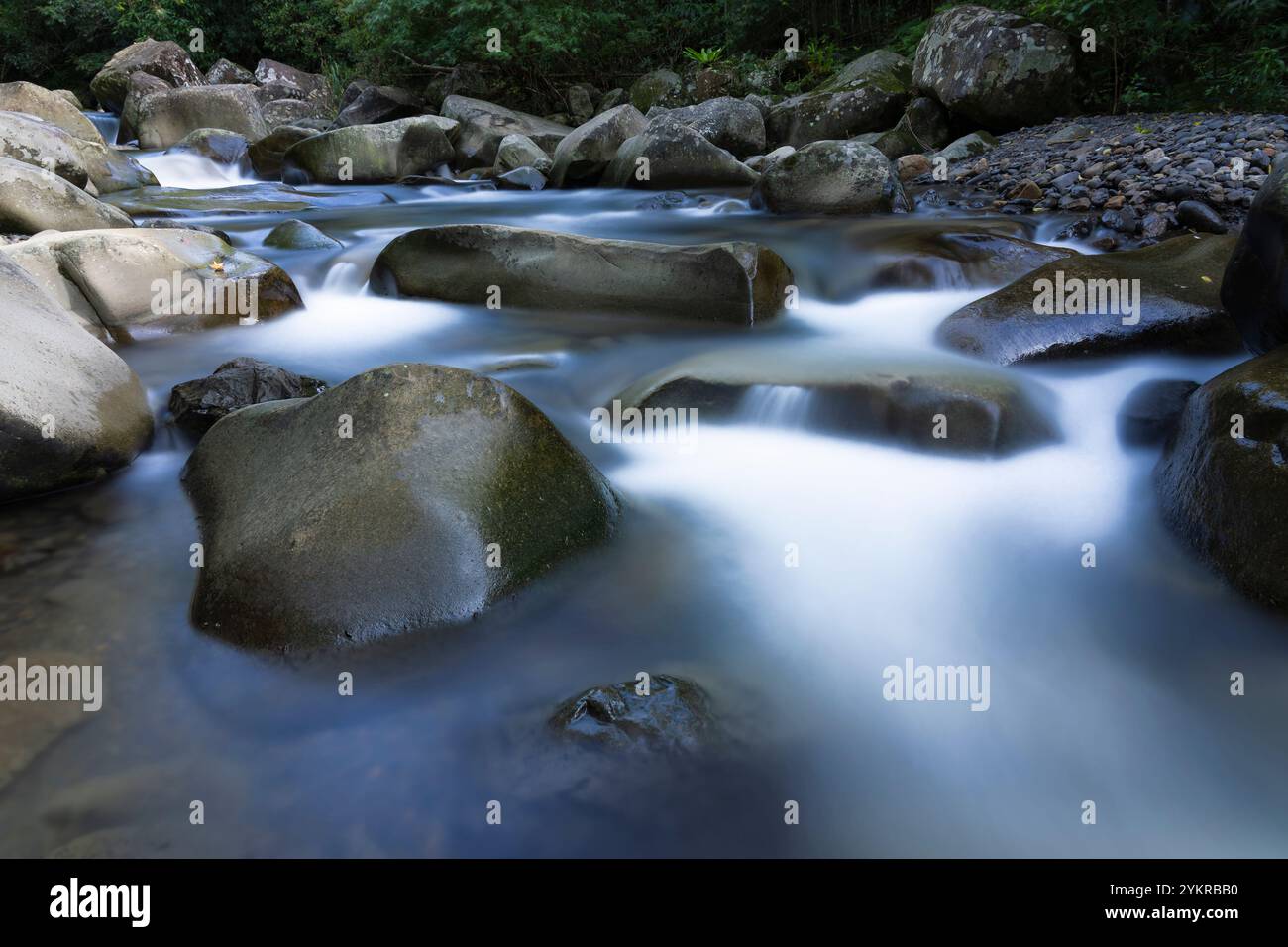 Slow shutter image of water flowing through the rocks creating a sooth ...