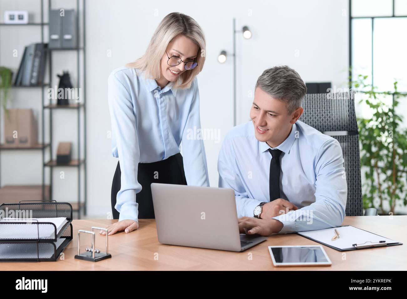 Middle aged employees working together in office Stock Photo - Alamy