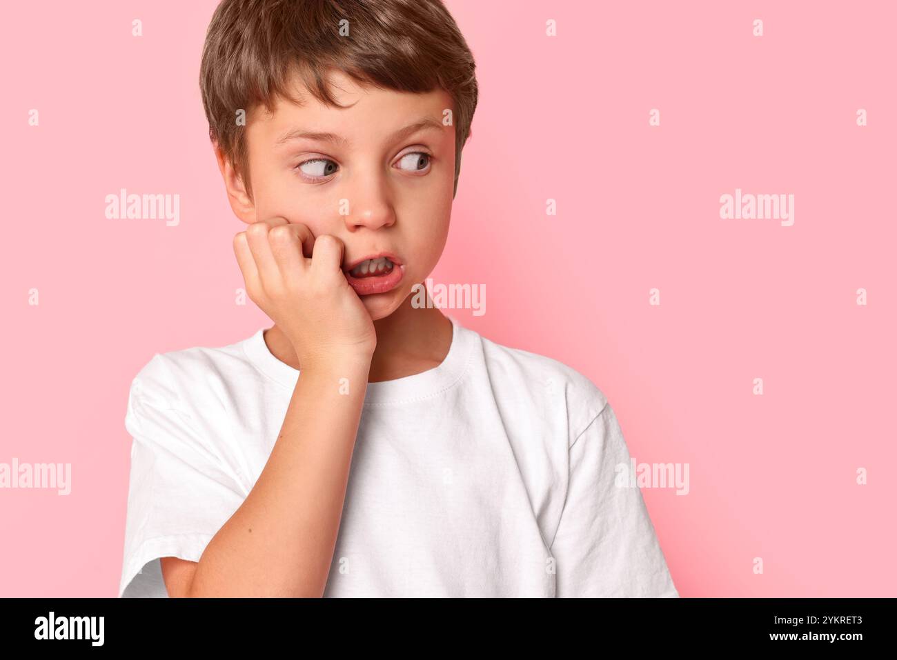 Portrait of scared little boy on pink background Stock Photo - Alamy
