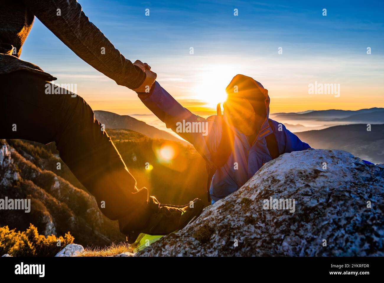 Hiking team people helping each other friend giving a helping hand ...