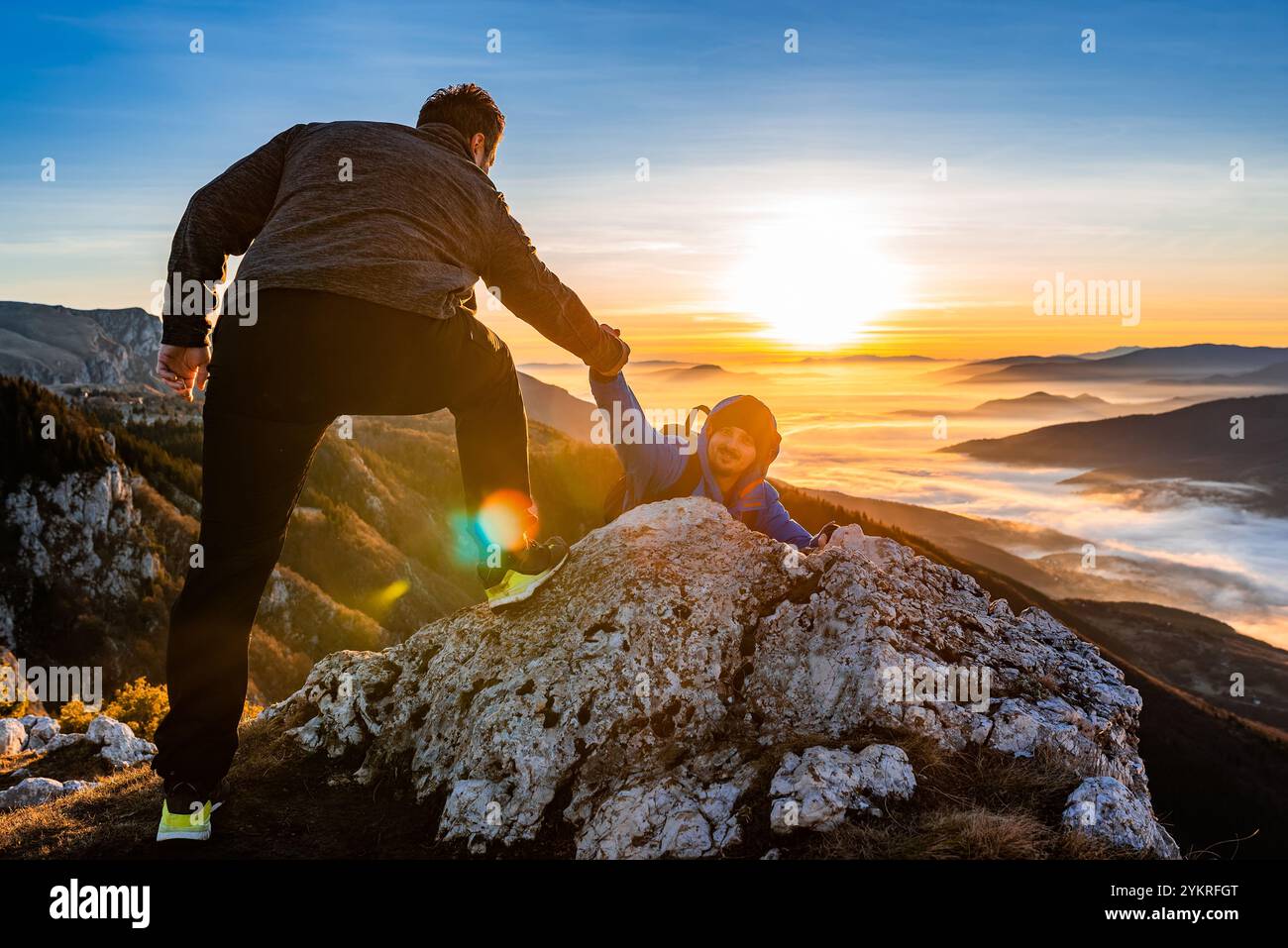 Hiking team people helping each other friend giving a helping hand ...