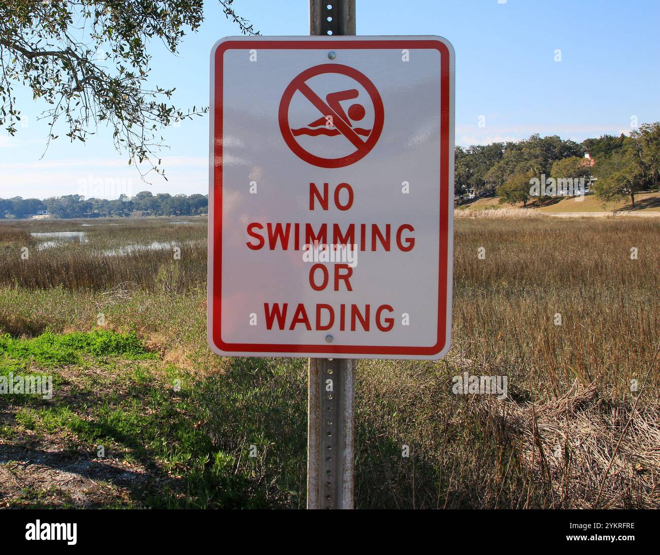 A clear warning sign indicates the restriction on swimming and wading ...