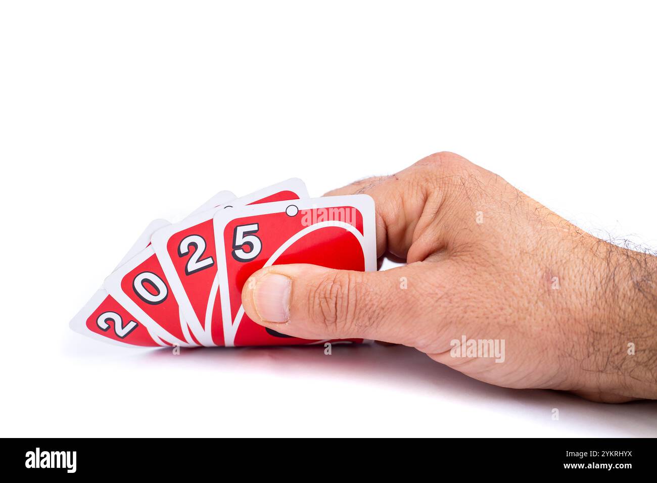 Hand holding red cards with 2025 numbers isolated on white background ...