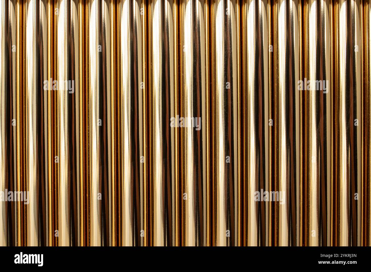 Golden pipes vertical stacked , abstract lines textured backdrop, close ...