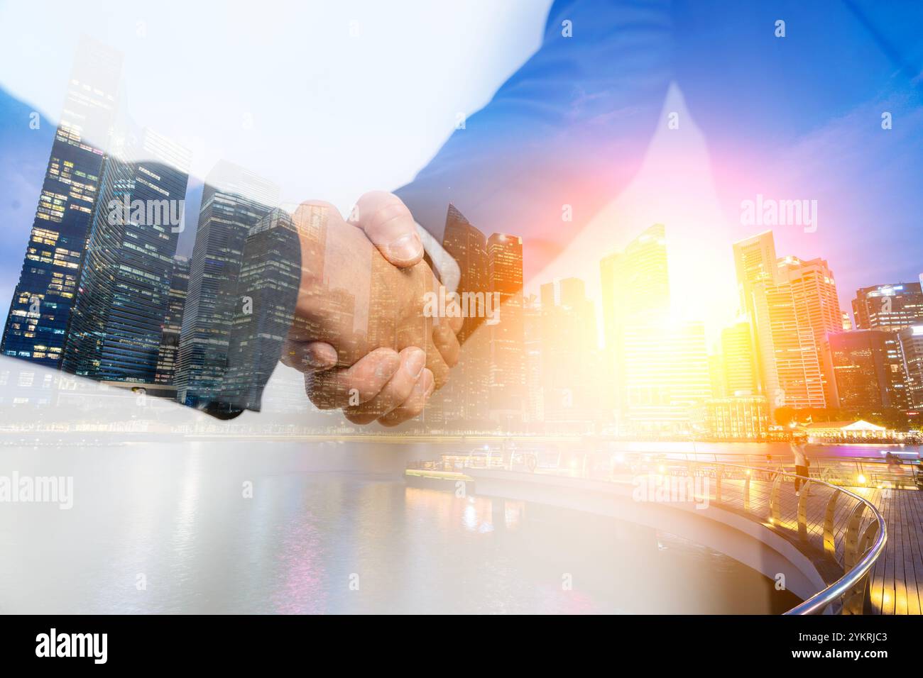 Businessmen making handshake with partner Stock Photo - Alamy