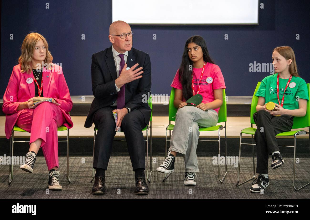 First Minister of Scotland John Swinney listens to Ellie Craig (left ...