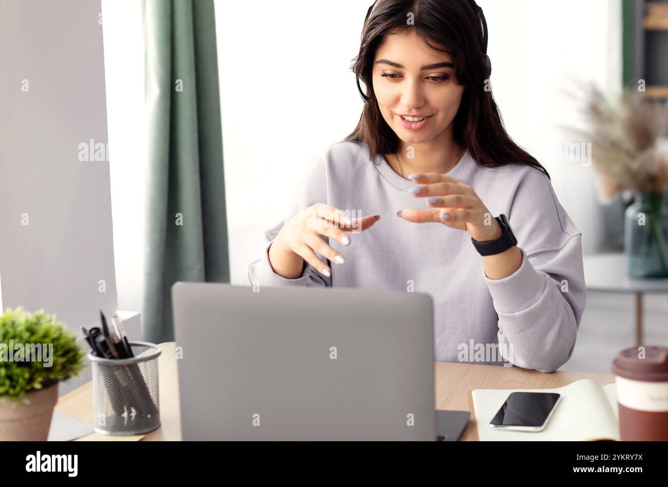 Woman having video call using laptop, talking and expaining Stock Photo ...