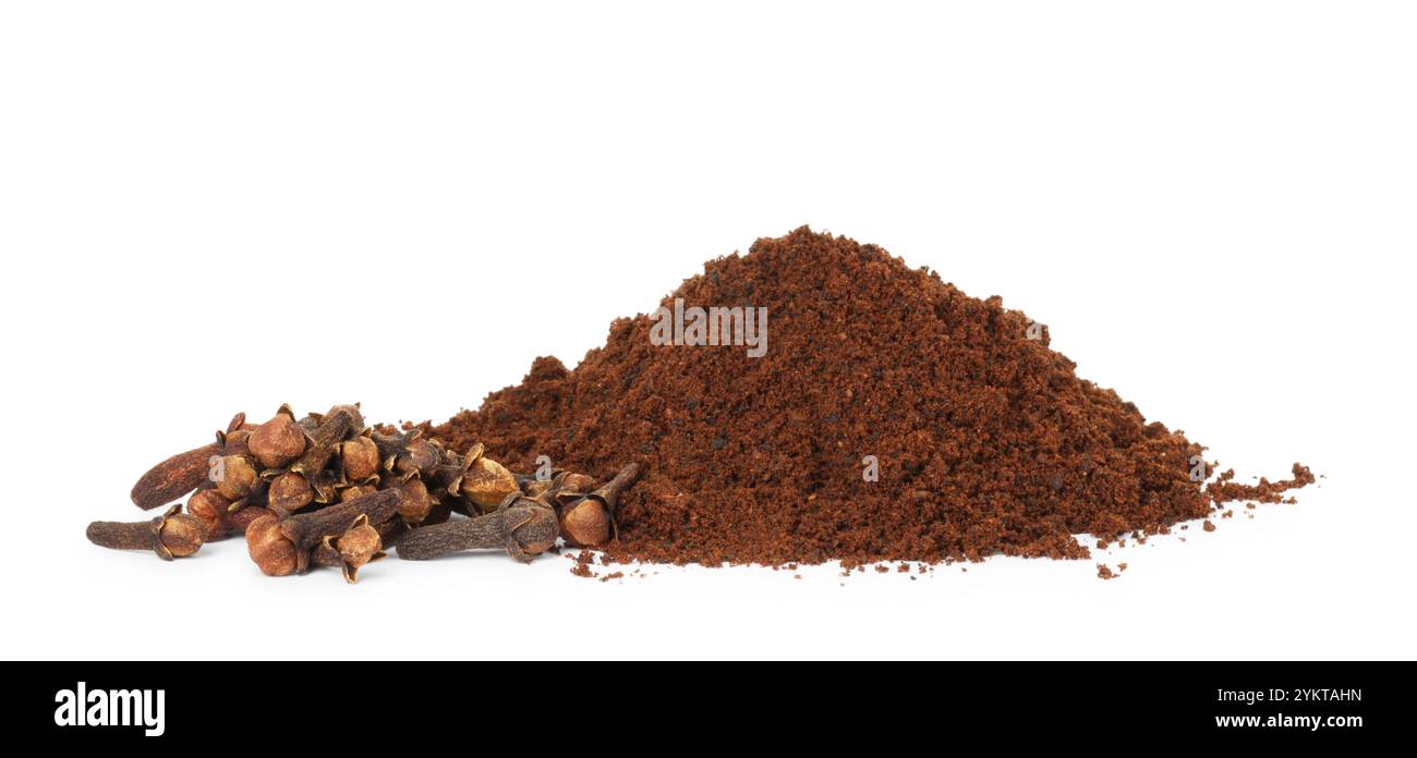 Pile of clove powder and dried buds on white background. Aromatic spice ...