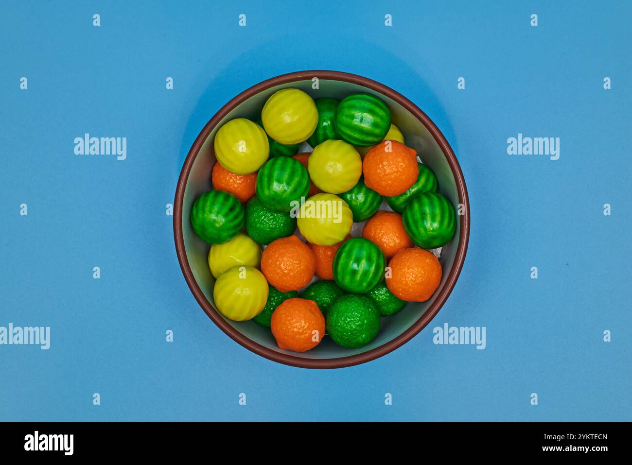 Gumballs of different colors and flavors representing fruits such as ...