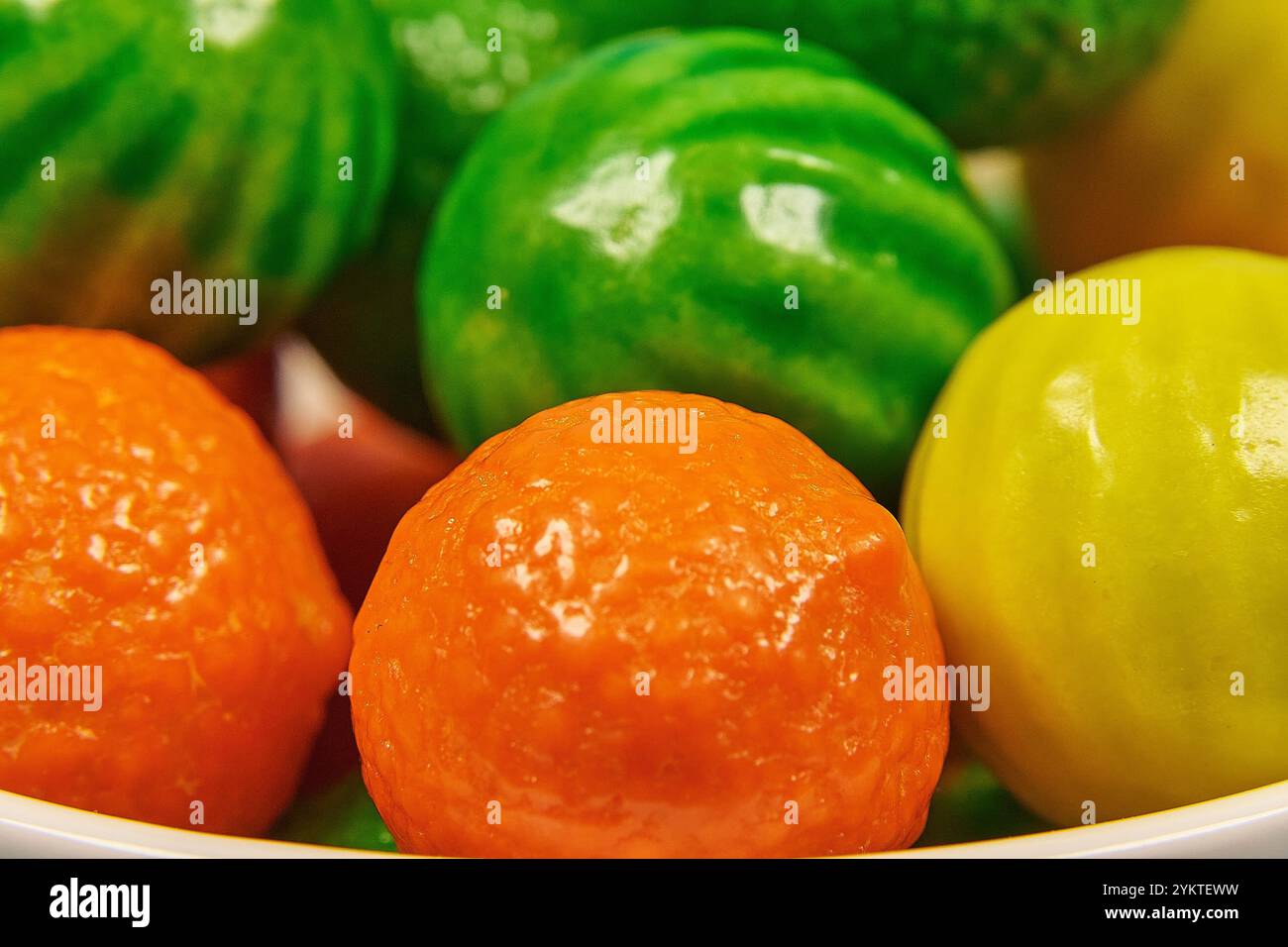 Gumballs of different colors and flavors representing fruits such as ...
