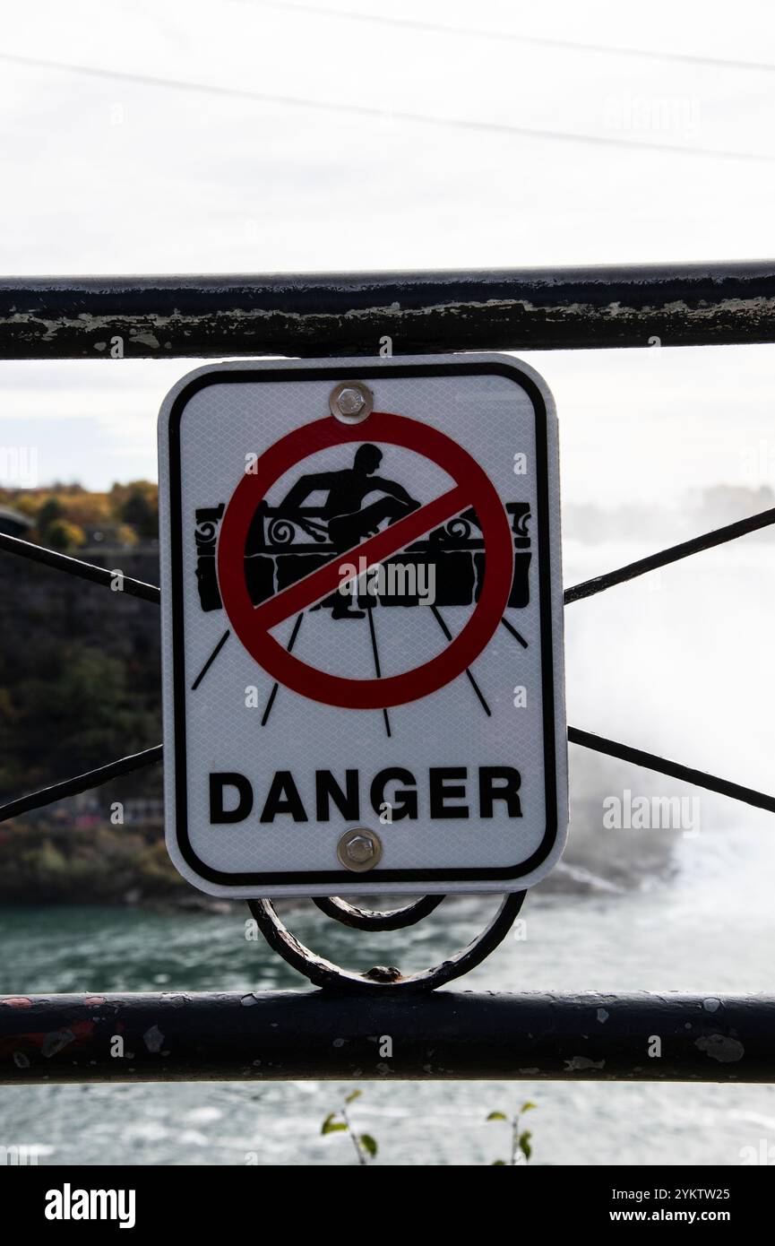 Danger sign posted on the railing in Niagara Falls, Ontario, Canada ...
