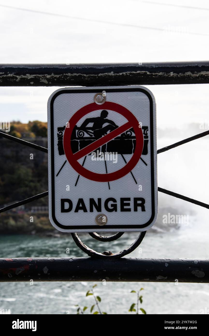 Danger sign posted on the railing in Niagara Falls, Ontario, Canada ...