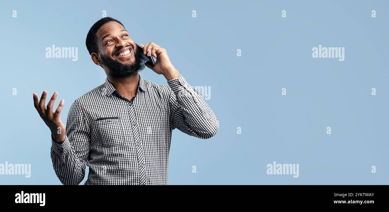 Surprised black guy talking on the phone and gesturing Stock Photo - Alamy