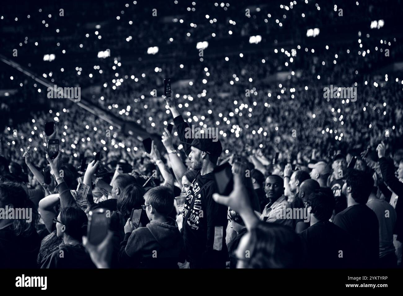 The crowd holding up cell phones in tribute to Bray Wyatt at AEW All In ...