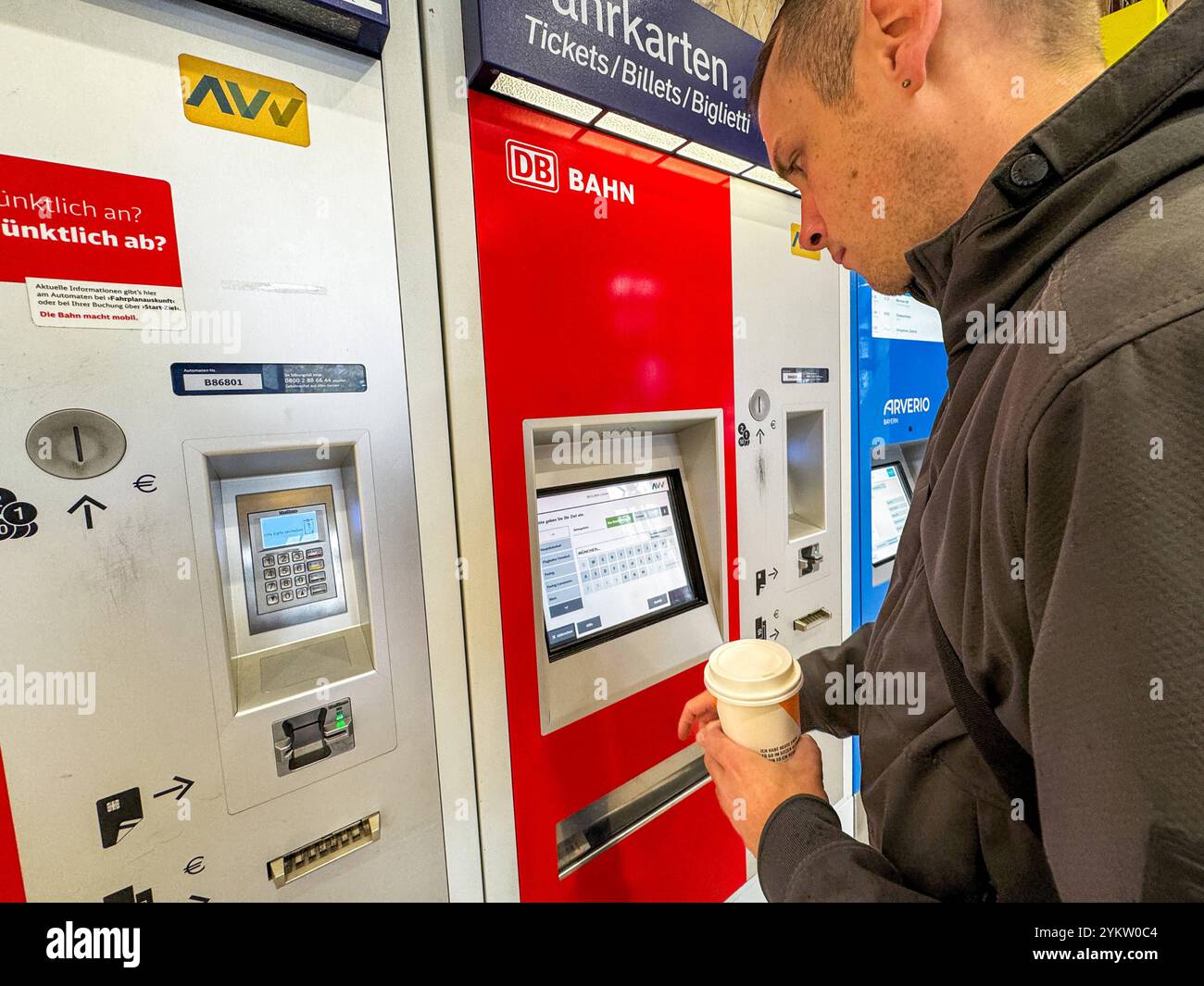Augsburg, Bavaria, Germany - November 18, 2024: Man buys a train ticket ...