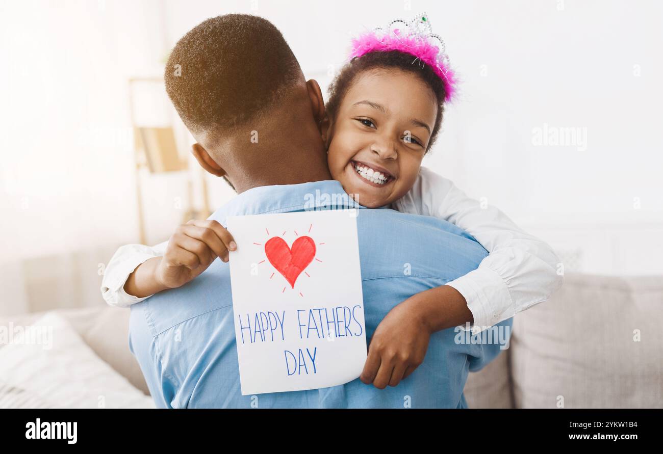 Little girl hugging dad and giving him postcard Stock Photo - Alamy