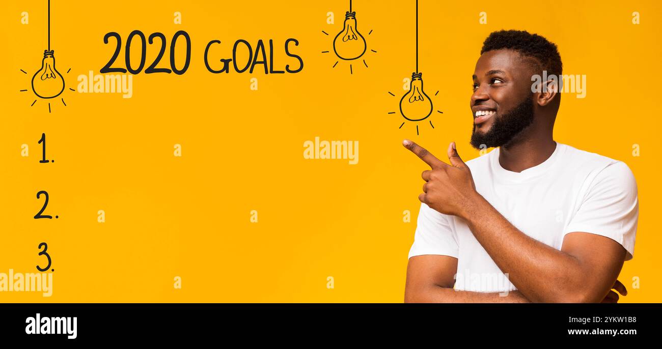 Cheerful black man pointing at checklist with 2020 goals Stock Photo ...