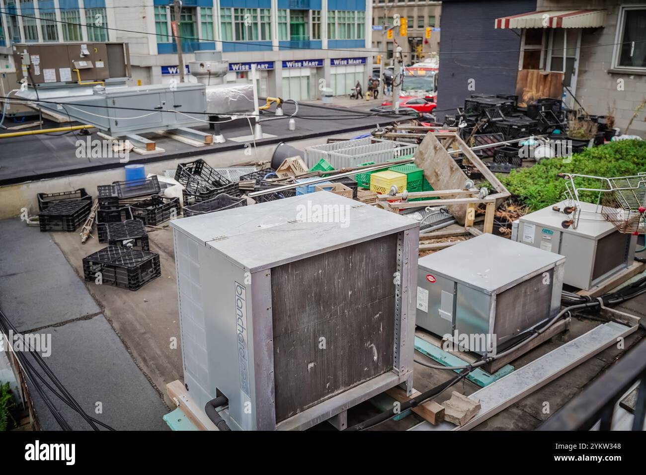 Cluttered rooftop of a single-story commercial building with plastic ...