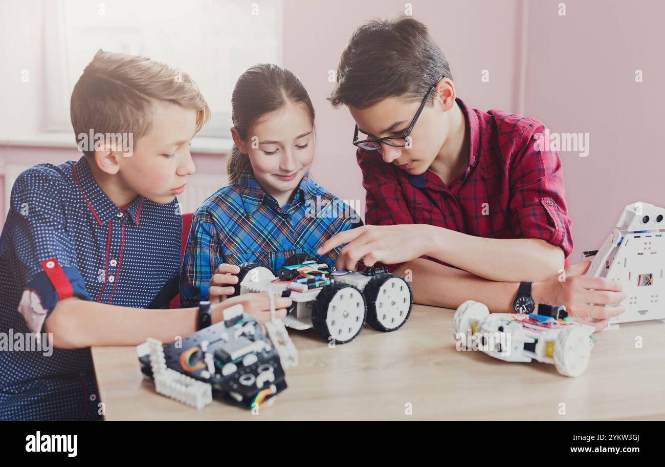Stem education. Kids creating robots at school Stock Photo - Alamy
